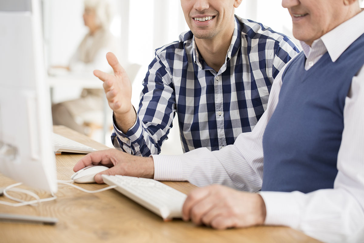 Lecturer helping older man - Newfoundland & Labrador Laubach Literacy ...